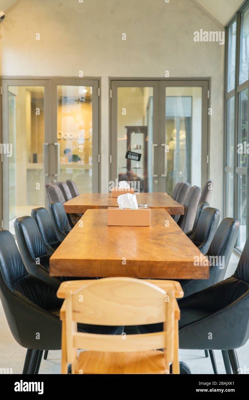 Meeting room with wooden table and comfortable chairs Stock Photo - Alamy