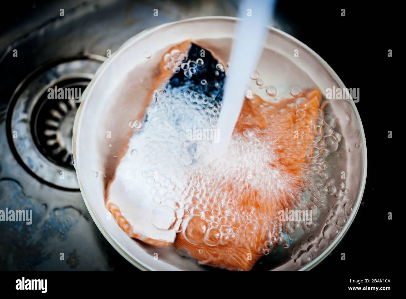 Clean water pouring washing inside kitchen stainless steel sink with ...