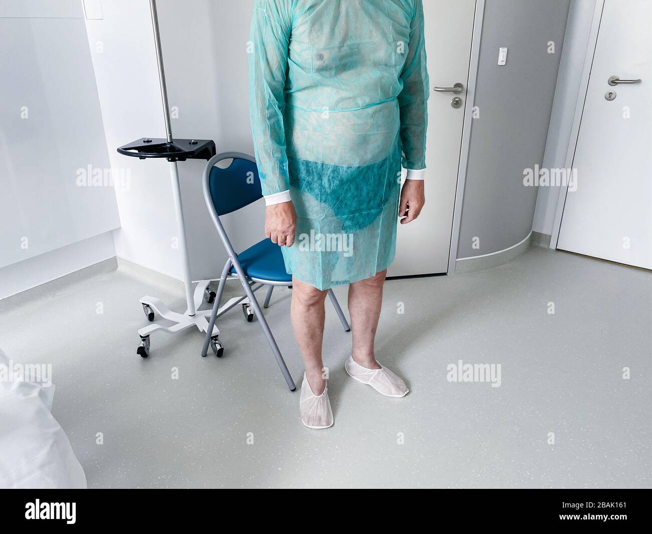 Low-height of senior male standing in the single patient isolated room ...