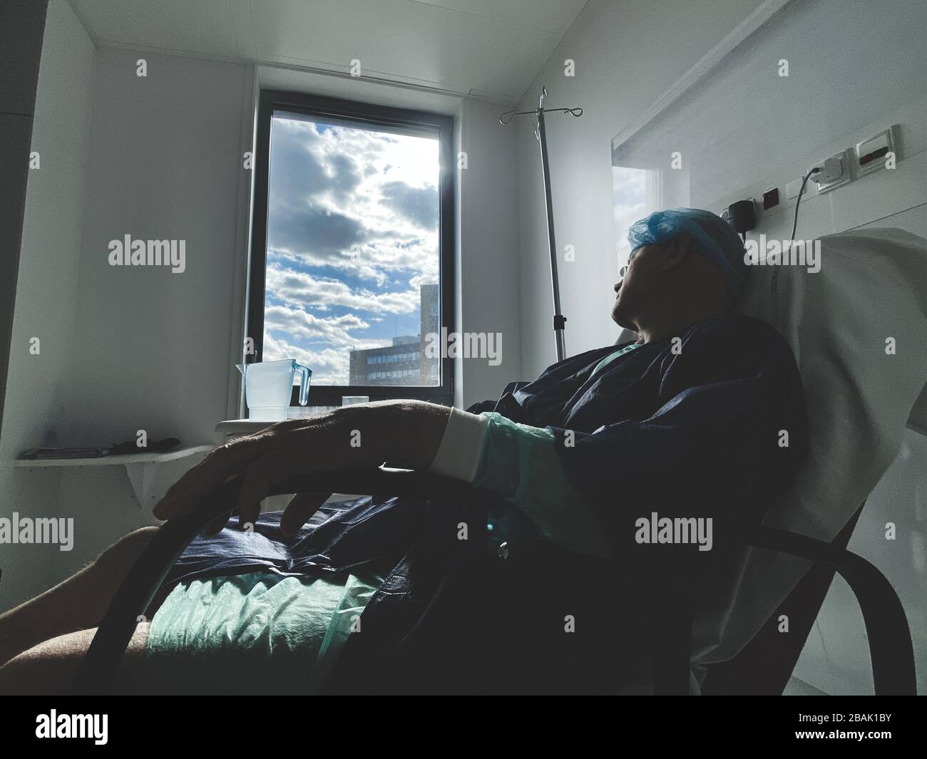 Lying on the medical chair senior male inside modern hospital in France ...