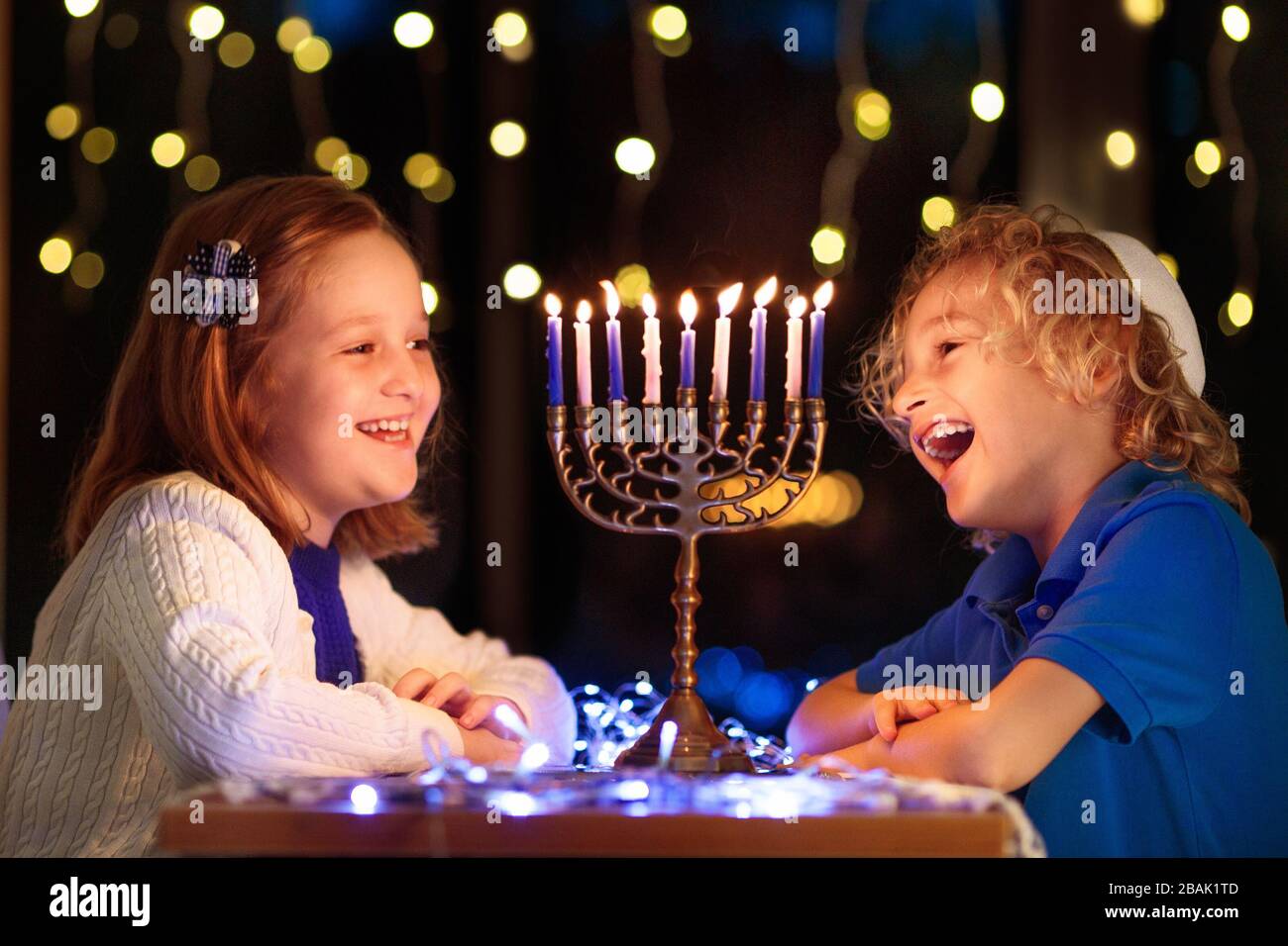 Kids celebrating Hanukkah. Jewish festival of lights. Children lighting ...