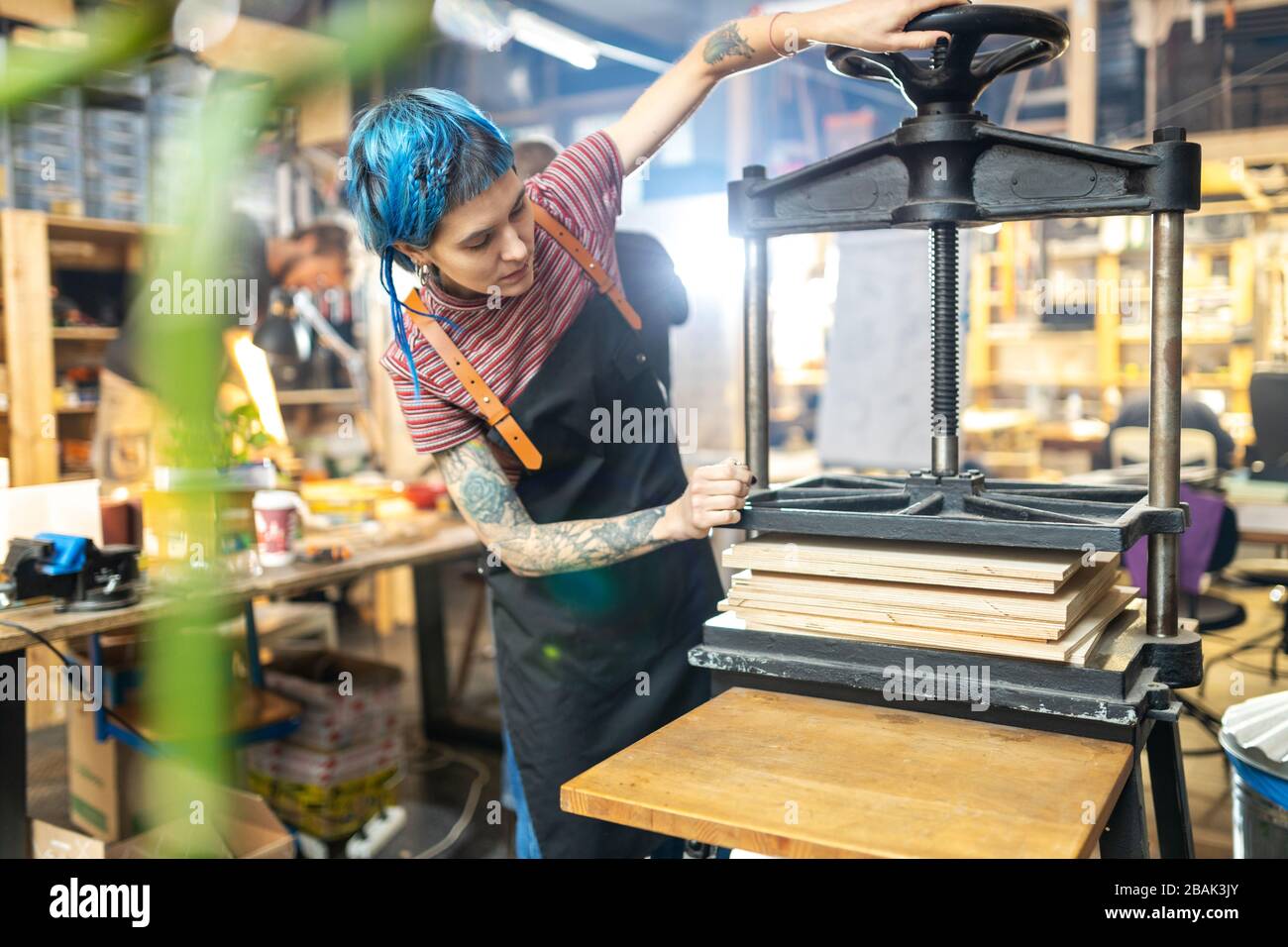 Young craftswoman during her work Stock Photo - Alamy