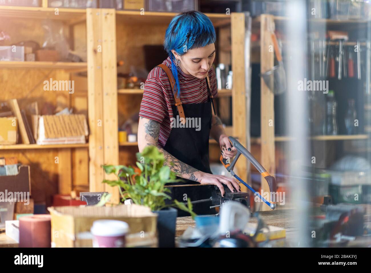 Young craftswoman during her work Stock Photo - Alamy