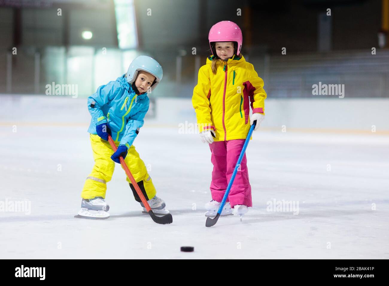 Children play ice hockey on indoor rink. Healthy winter sport for kids ...