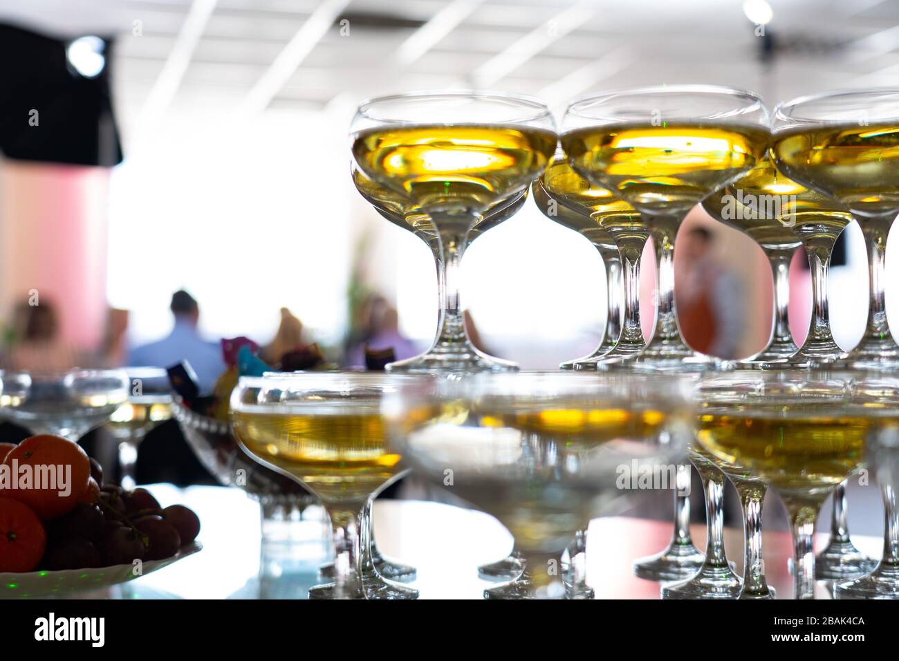 A pyramid of glasses of champagne. White sparkling wine in glasses ...