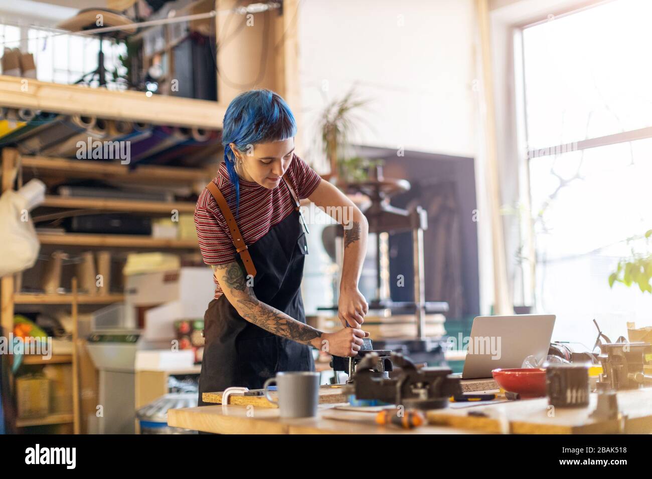 Young craftswoman during her work Stock Photo - Alamy