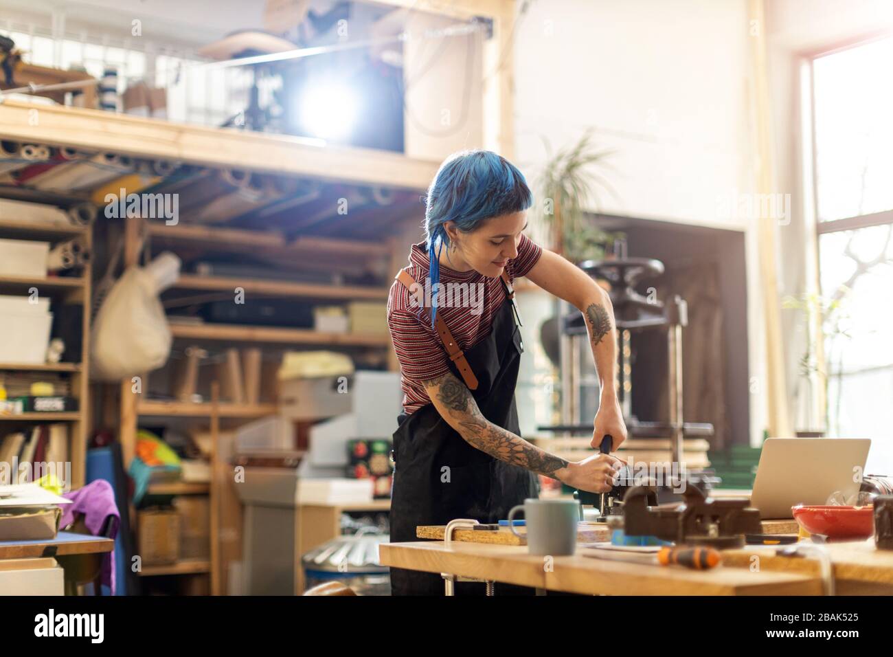 Young craftswoman during her work Stock Photo - Alamy