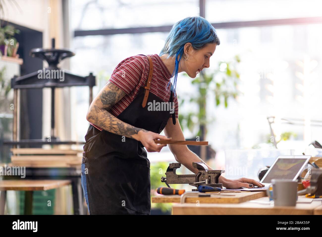 Young craftswoman during her work Stock Photo - Alamy