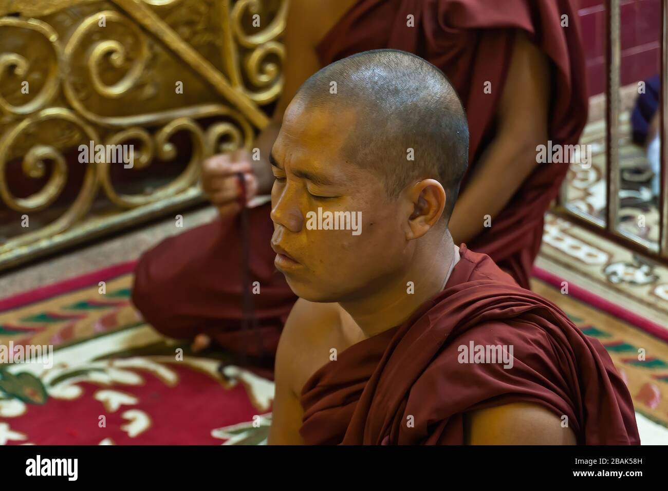 Buddhist monks praying in the Mahamuni Buddha Temple, Mandalay, Myanmar ...
