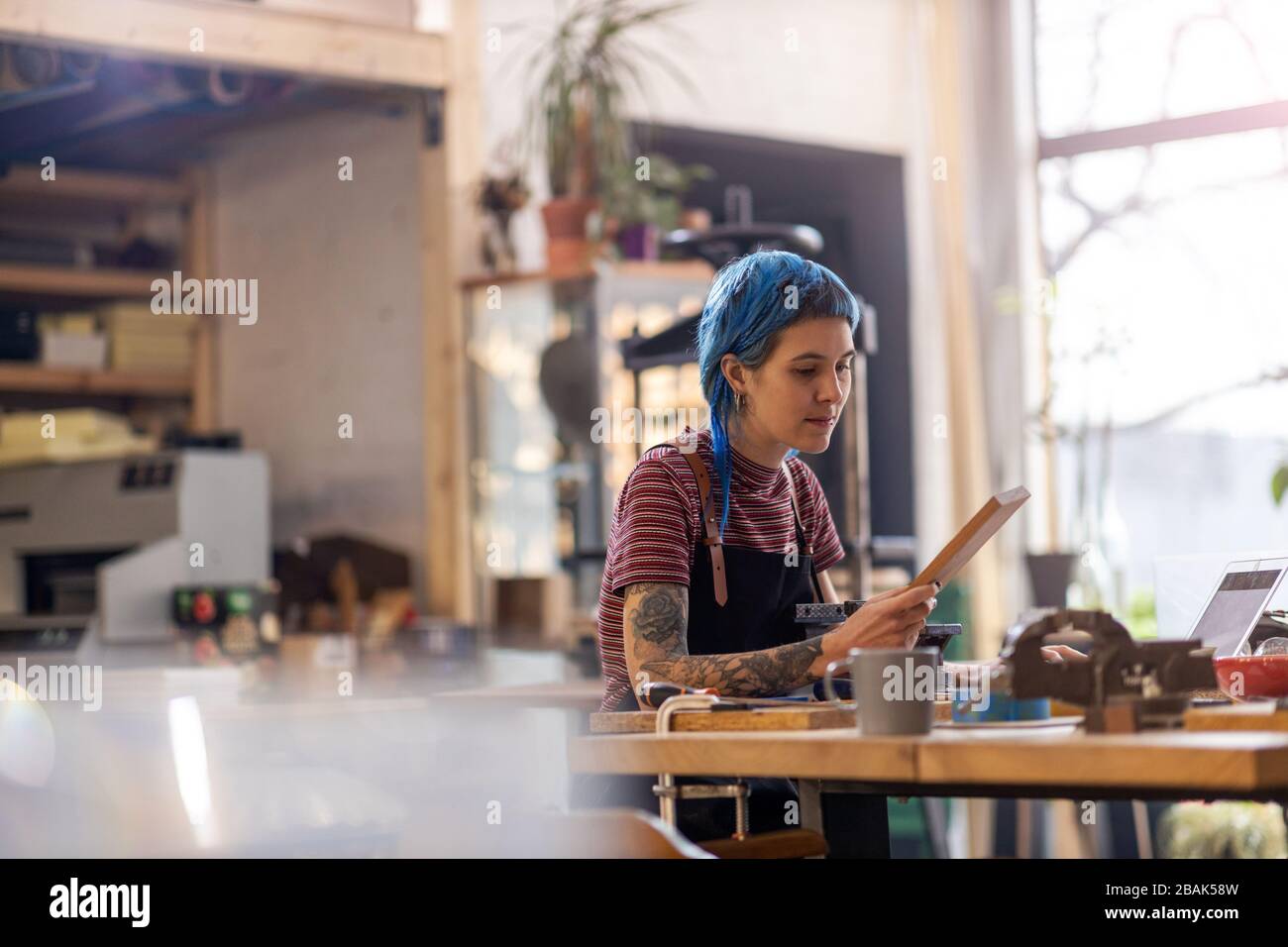 Young craftswoman during her work Stock Photo - Alamy