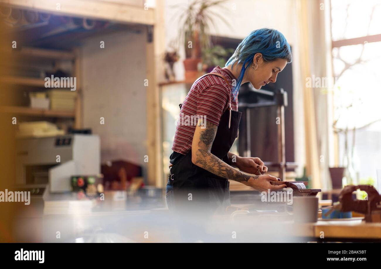 Young craftswoman during her work Stock Photo - Alamy