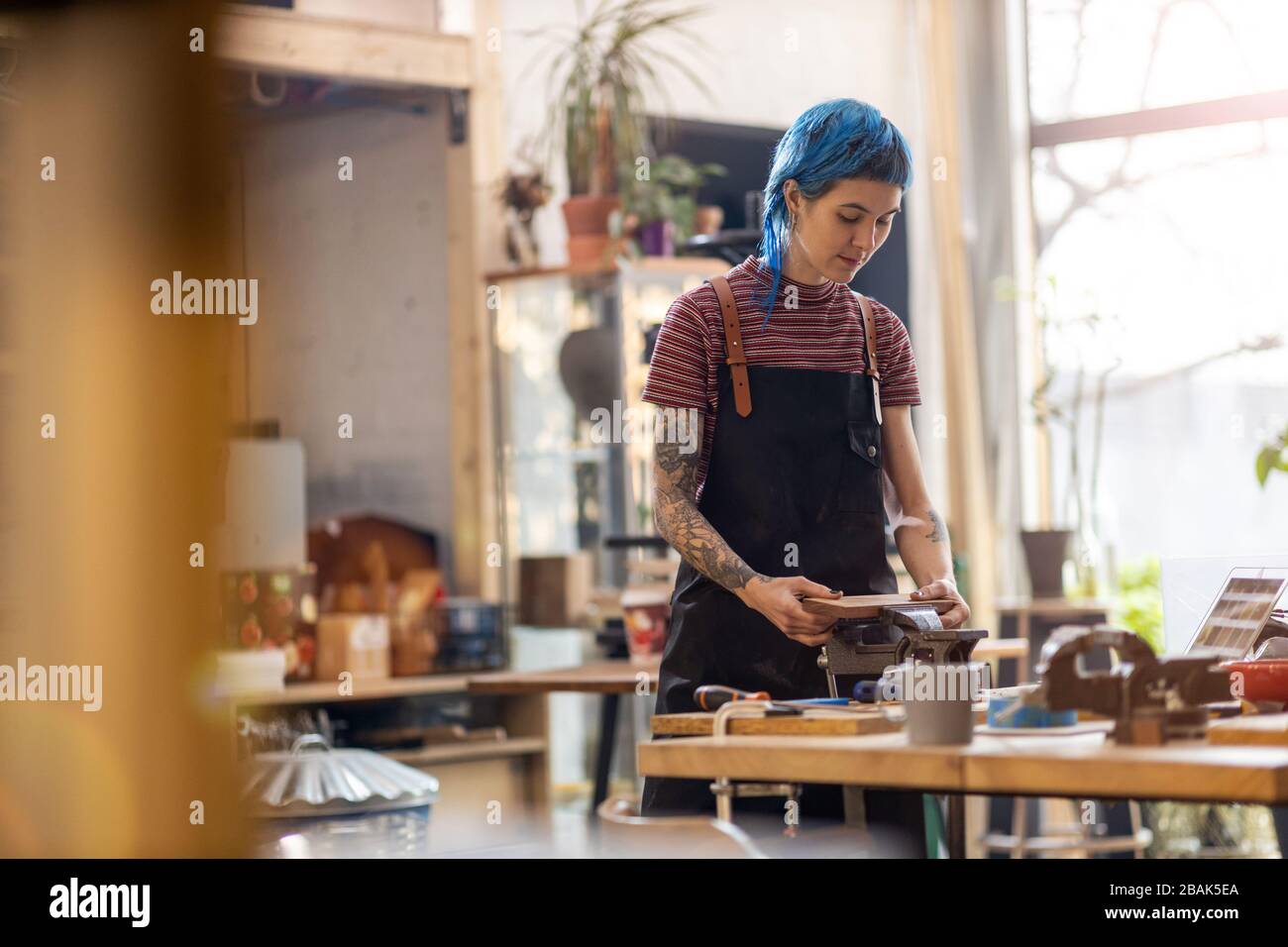 Young craftswoman during her work Stock Photo - Alamy
