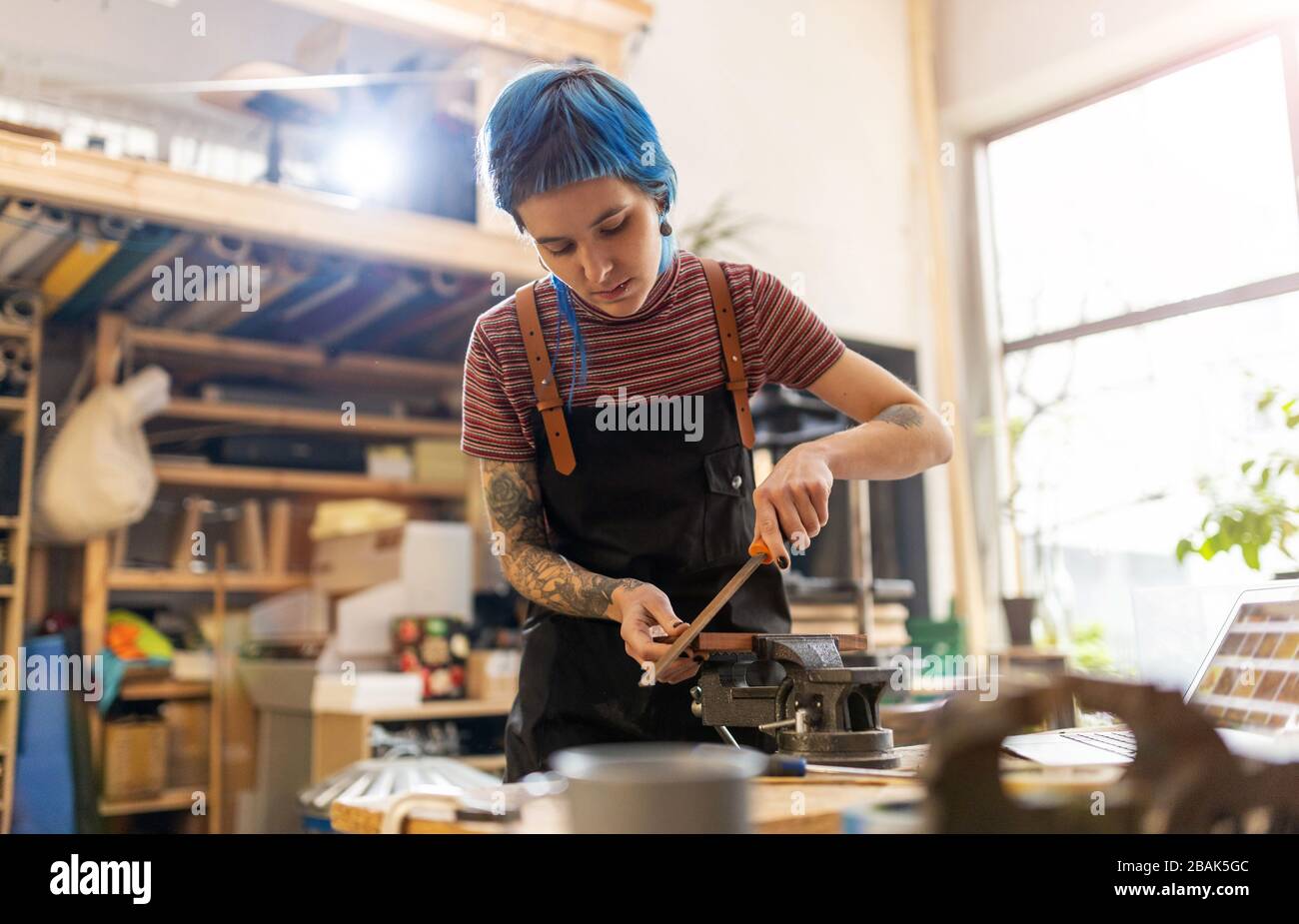 Young craftswoman during her work Stock Photo - Alamy