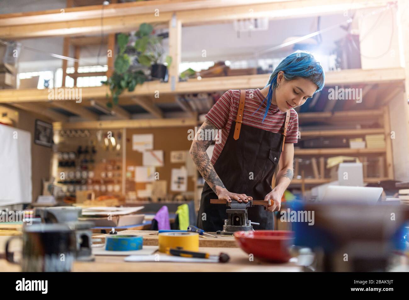 Young craftswoman during her work Stock Photo - Alamy