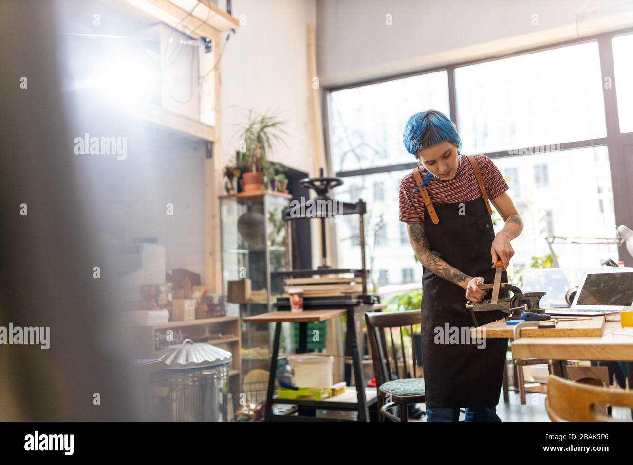 Young craftswoman during her work Stock Photo - Alamy