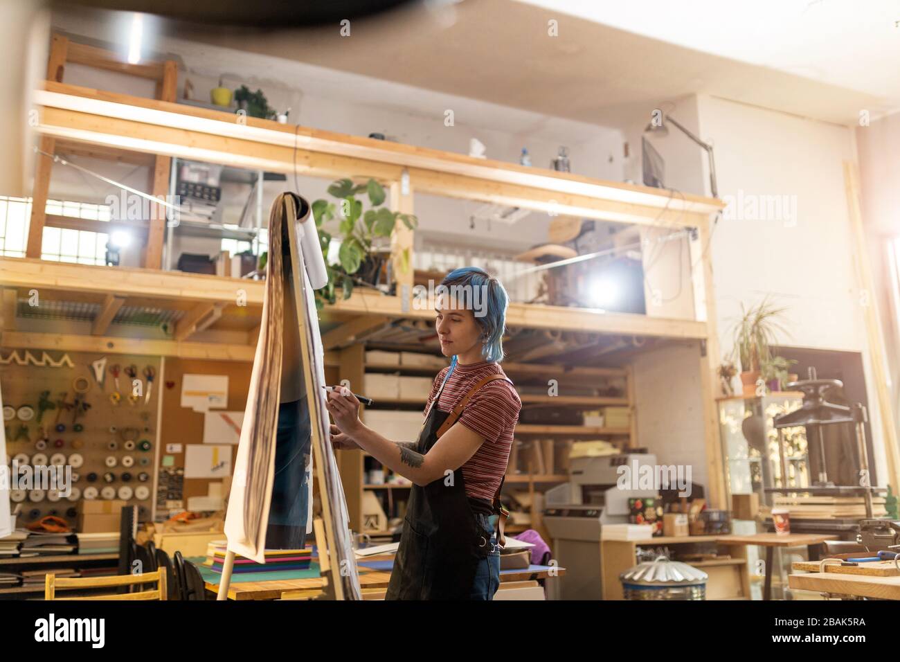 Young craftswoman during her work Stock Photo - Alamy