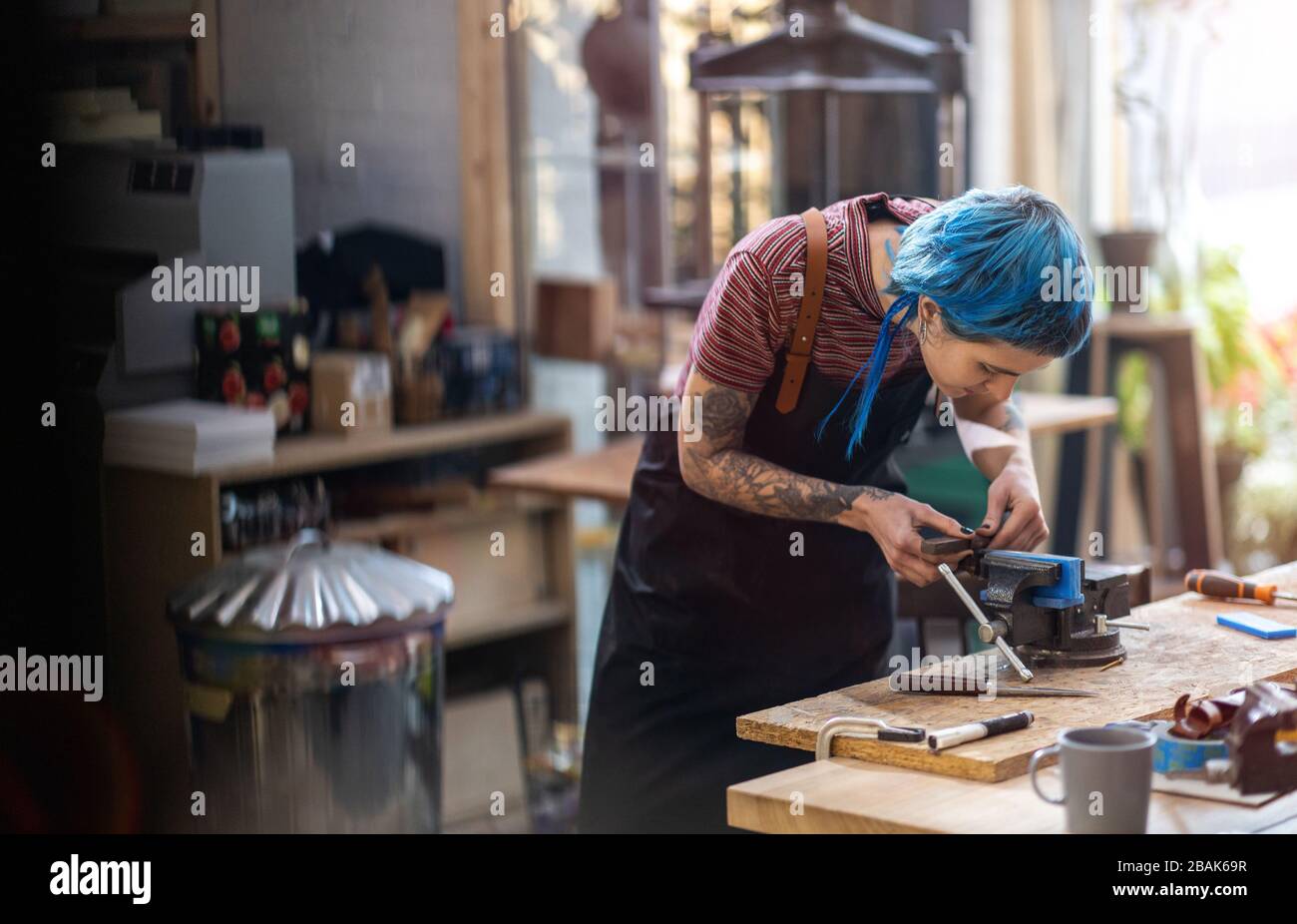 Young craftswoman during her work Stock Photo - Alamy