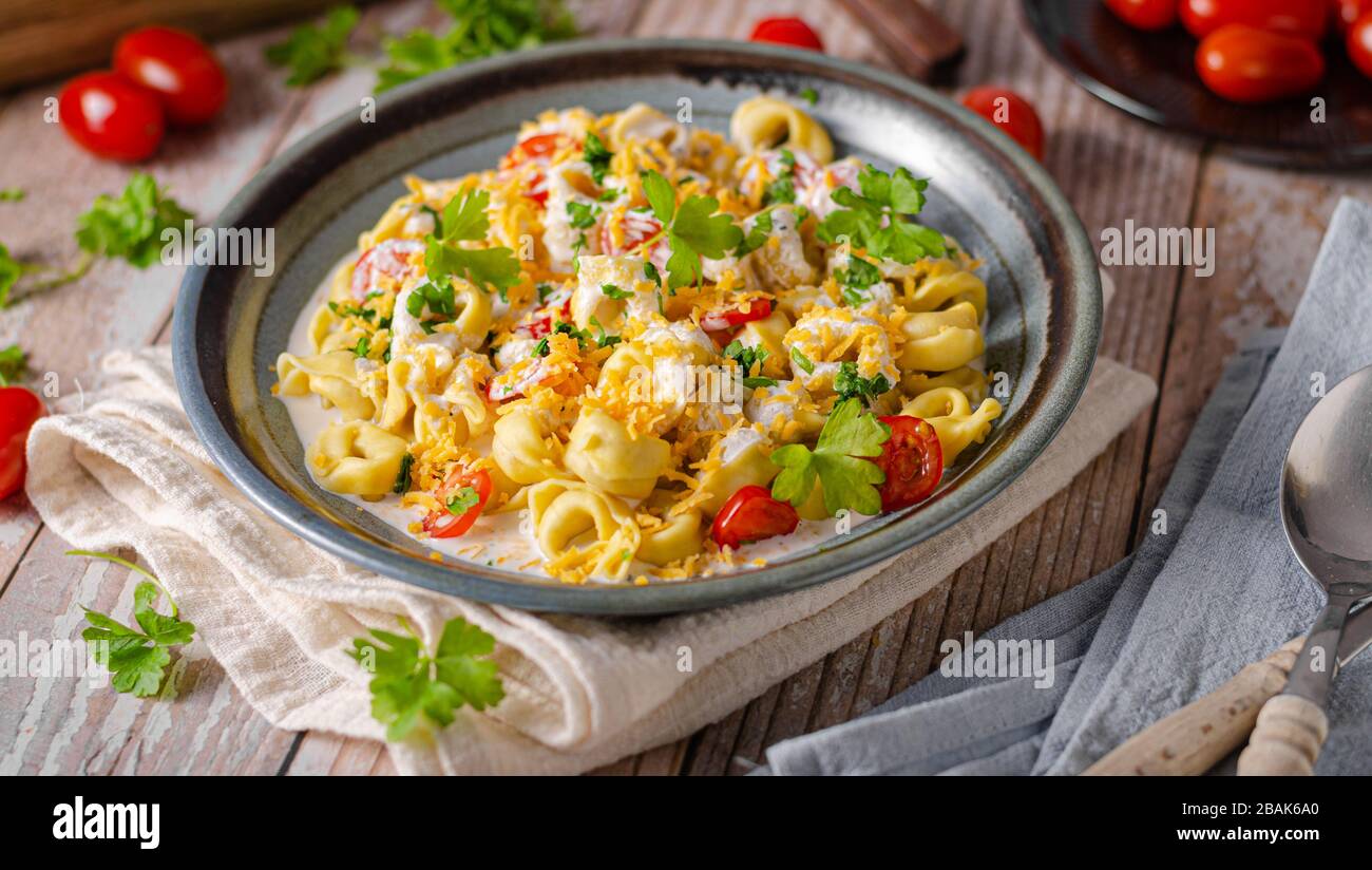 Italian tortellini with herbs and cheese sauce Stock Photo - Alamy