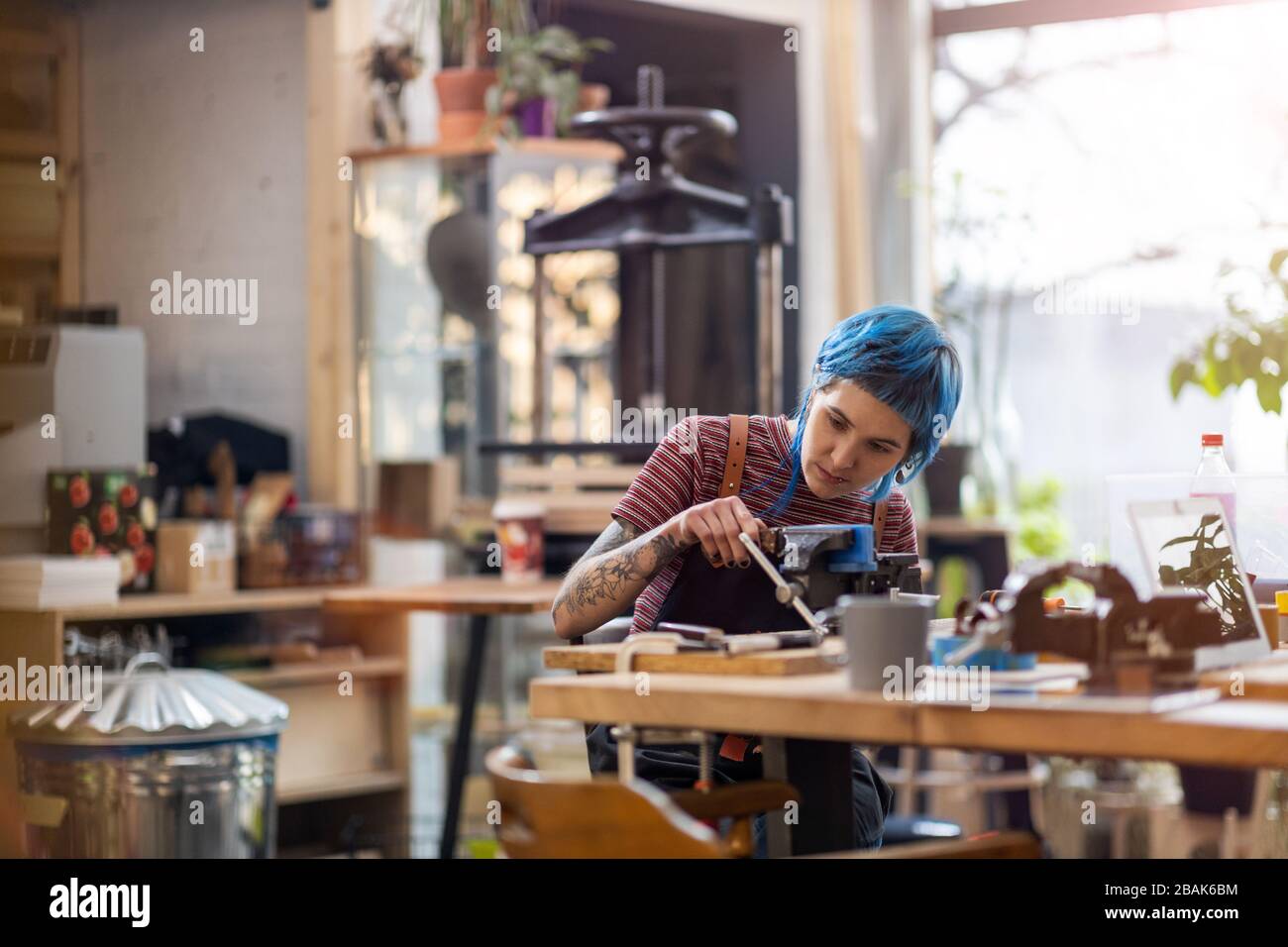 Young craftswoman during her work Stock Photo - Alamy