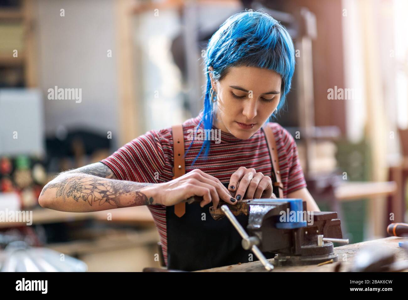 Young craftswoman during her work Stock Photo - Alamy