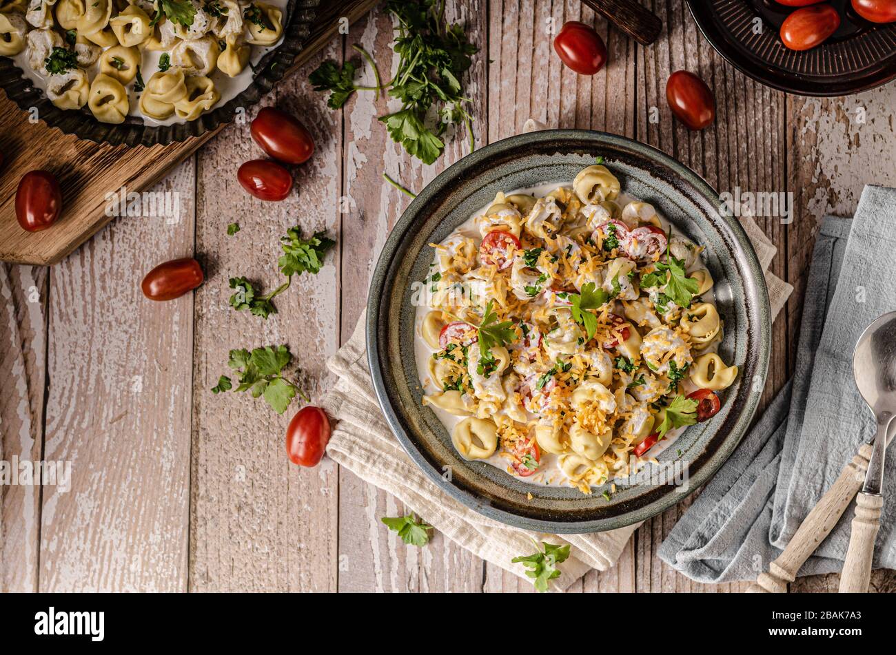 Italian tortellini with herbs and cheese sauce Stock Photo - Alamy
