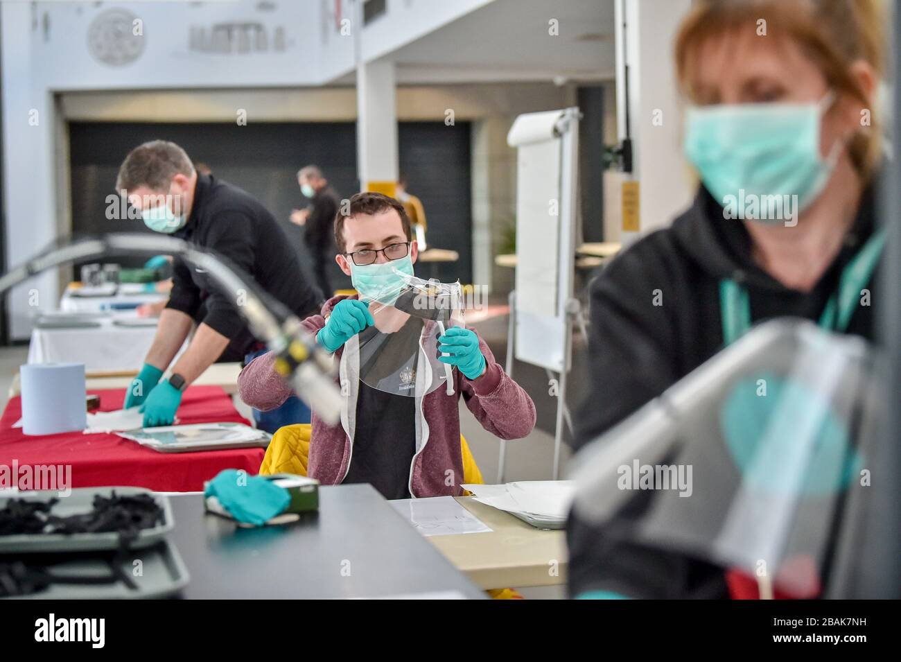 Royal Mint employees assemble full face visors in the cafe inside the ...