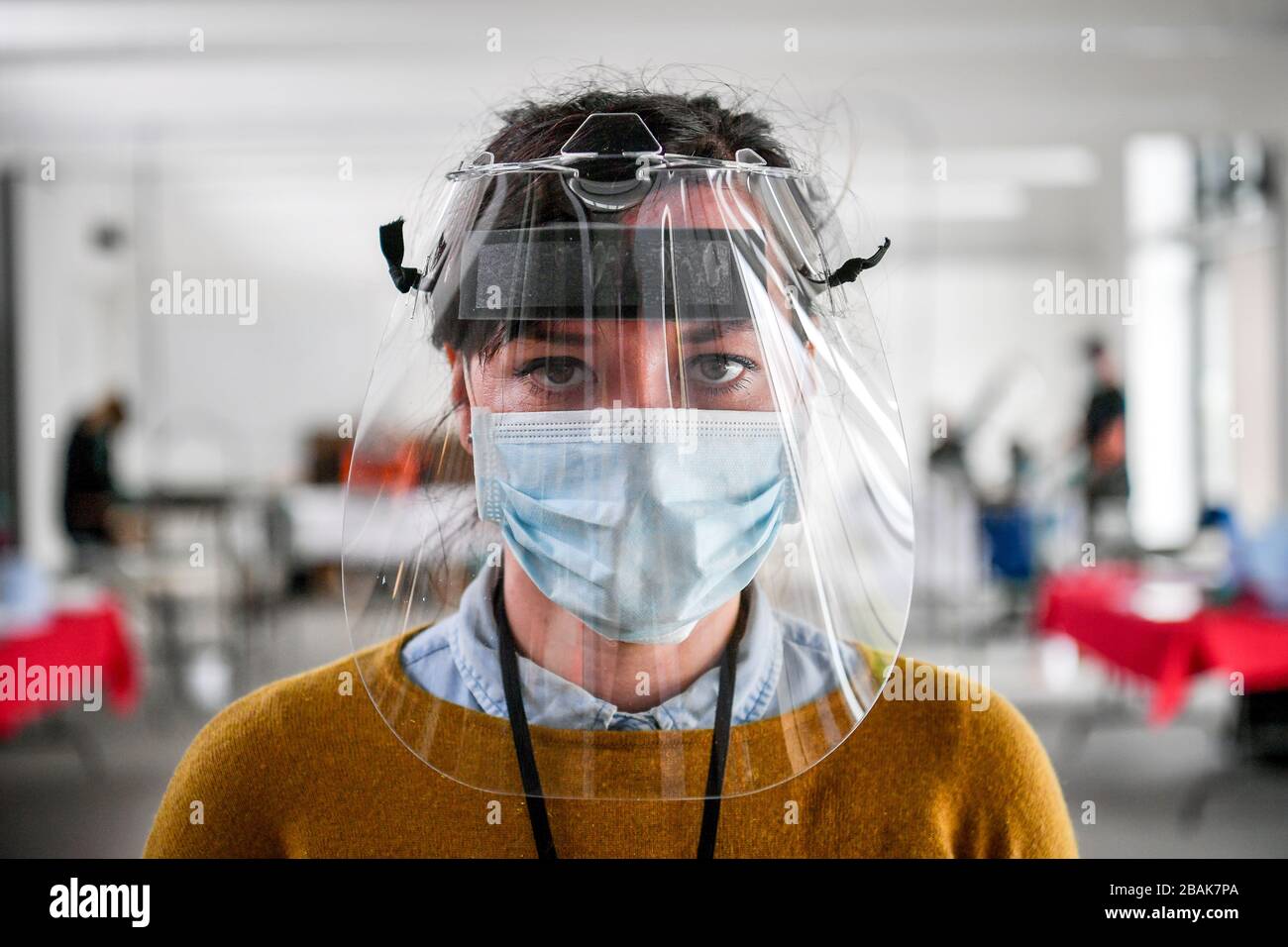 A Royal Mint employee checks the fit of a full face visor where workers ...