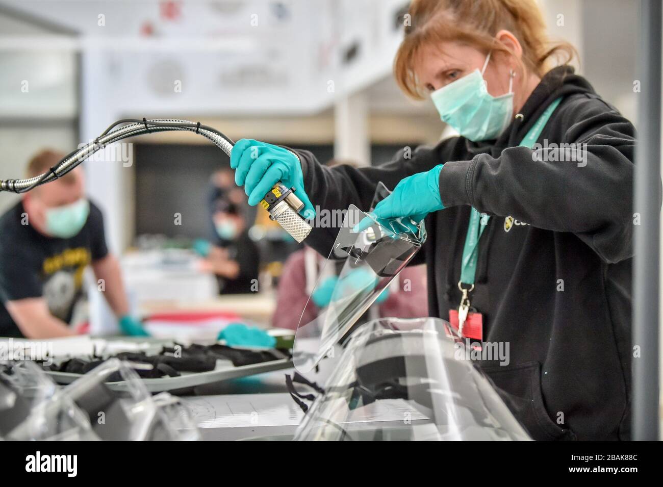 Royal Mint employees assemble full face visors in the cafe inside the ...