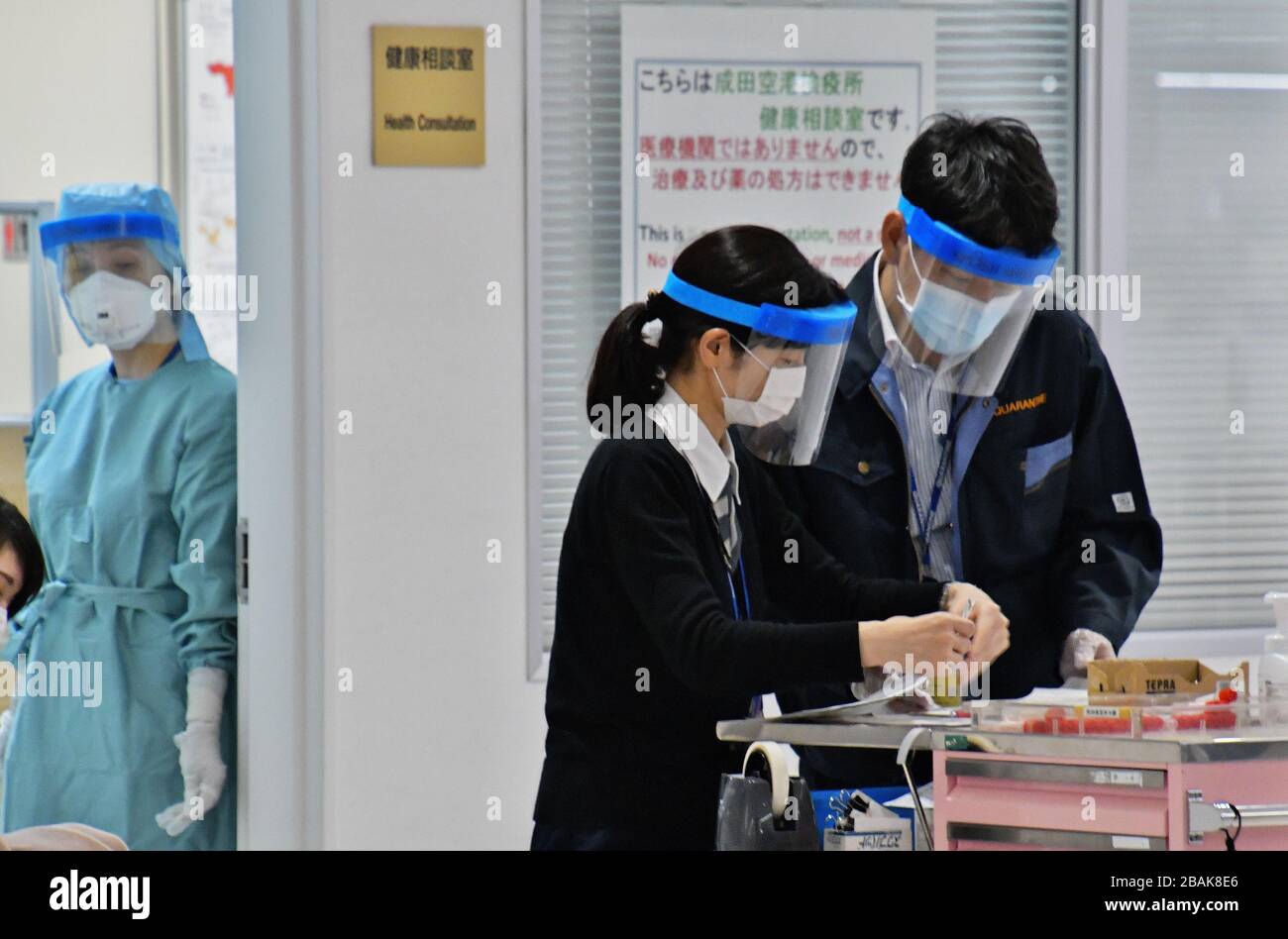 Narita, Japan. 28th Mar, 2020. Quarantine officers wearing face masks ...