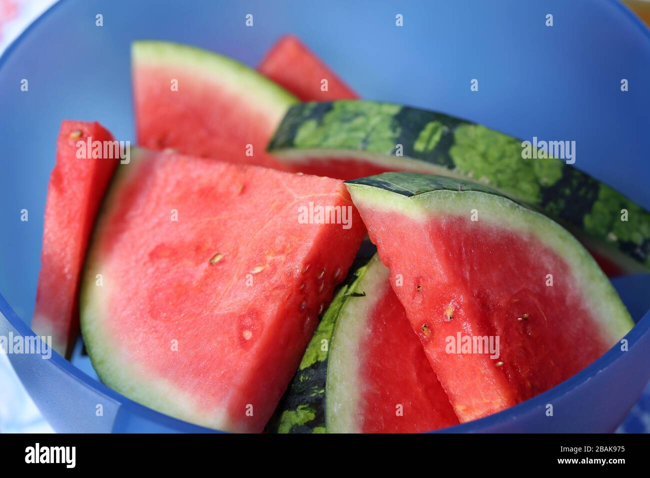 Juicy, healthy and fresh watermelon slices in a blue plastic bowl ...