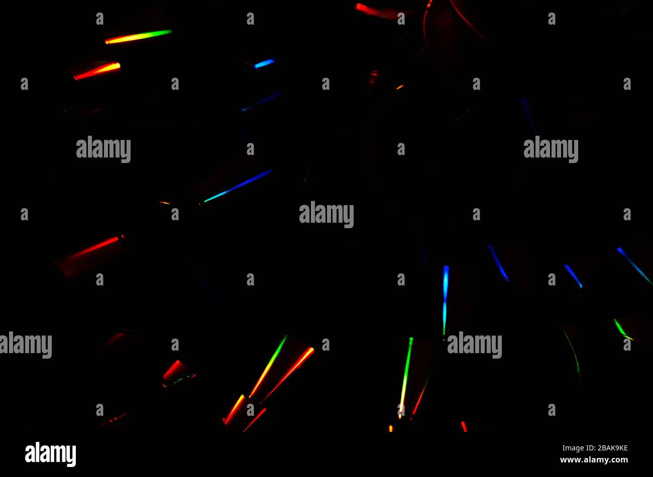 Abstract dark background of rainbow iridescent light streaks. Prismatic ...