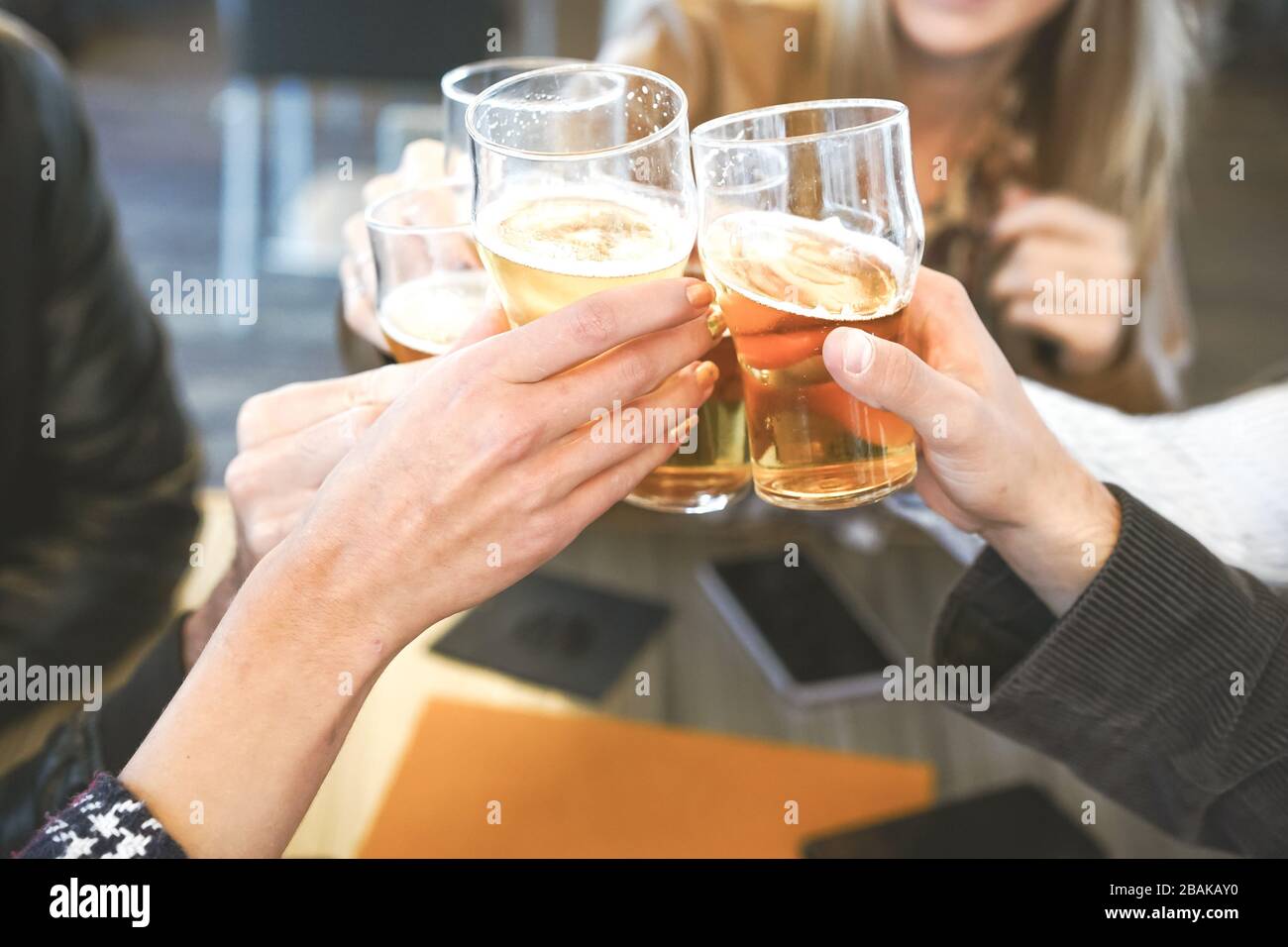 Friends Showing Hands While Holding Glasses Of Beer And Cheering With