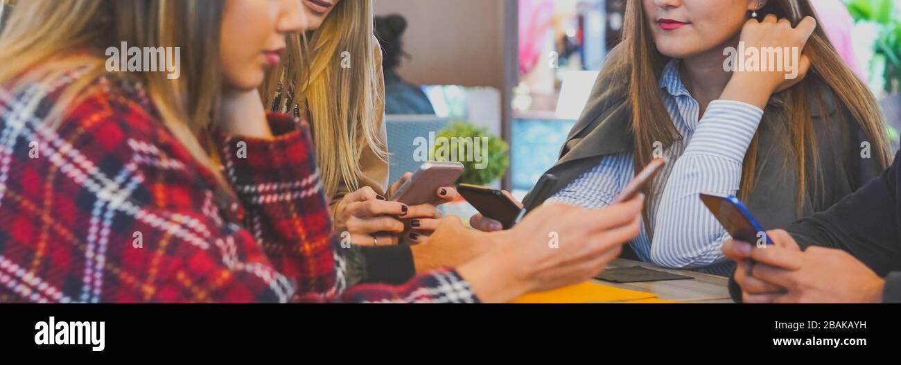 Group of friends hanging out with each other sitting in a bar using ...