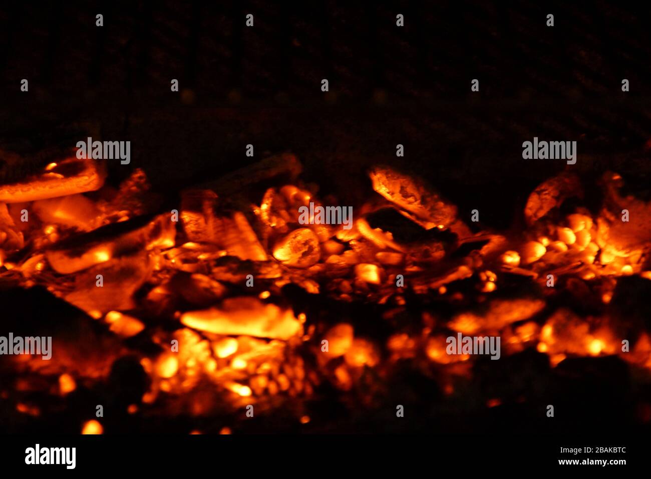 Embers in the barbecue, with an orange bright color Stock Photo - Alamy