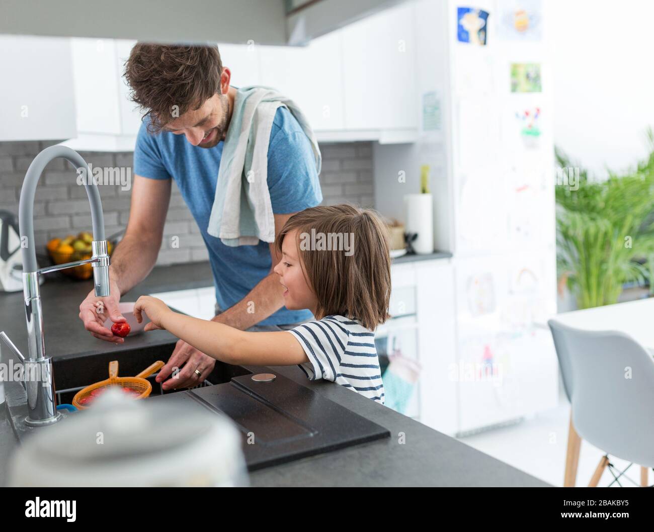 Children helping father in kitchen Stock Photo - Alamy