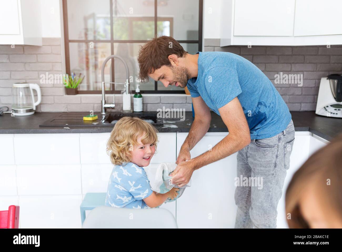 Children helping father in kitchen Stock Photo - Alamy