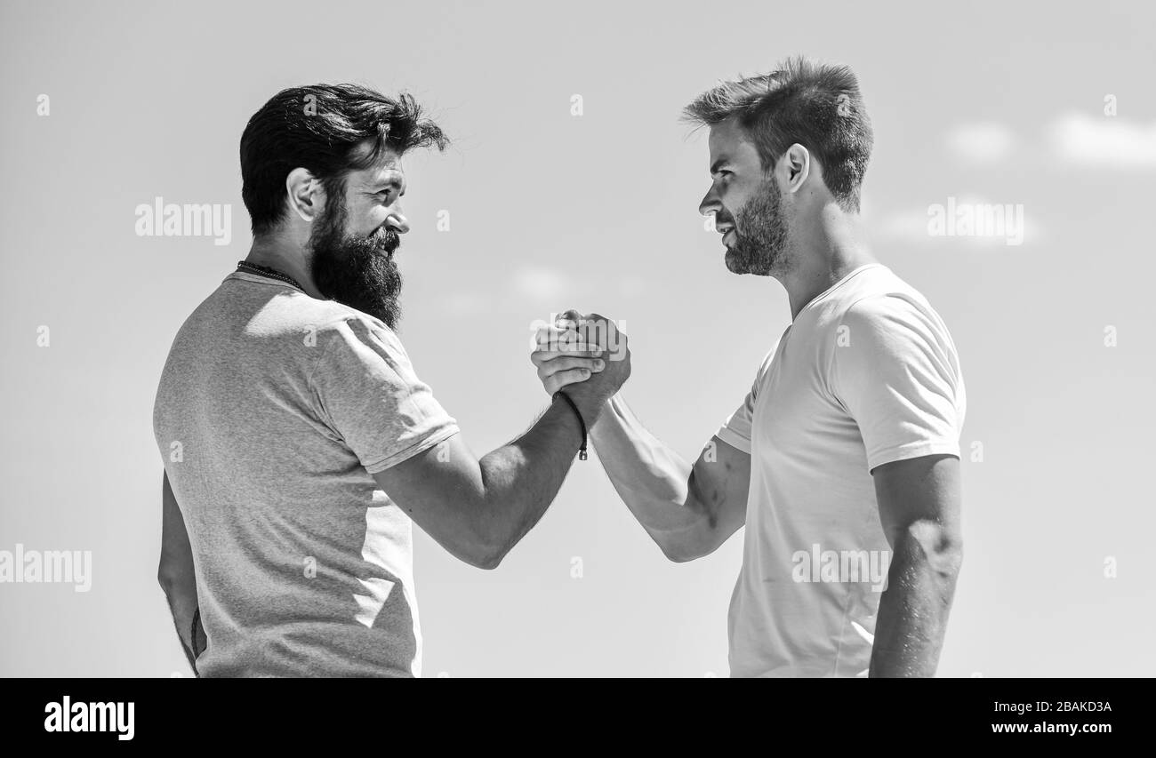 Strong and muscular arms. Successful deal handshake blue sky background ...