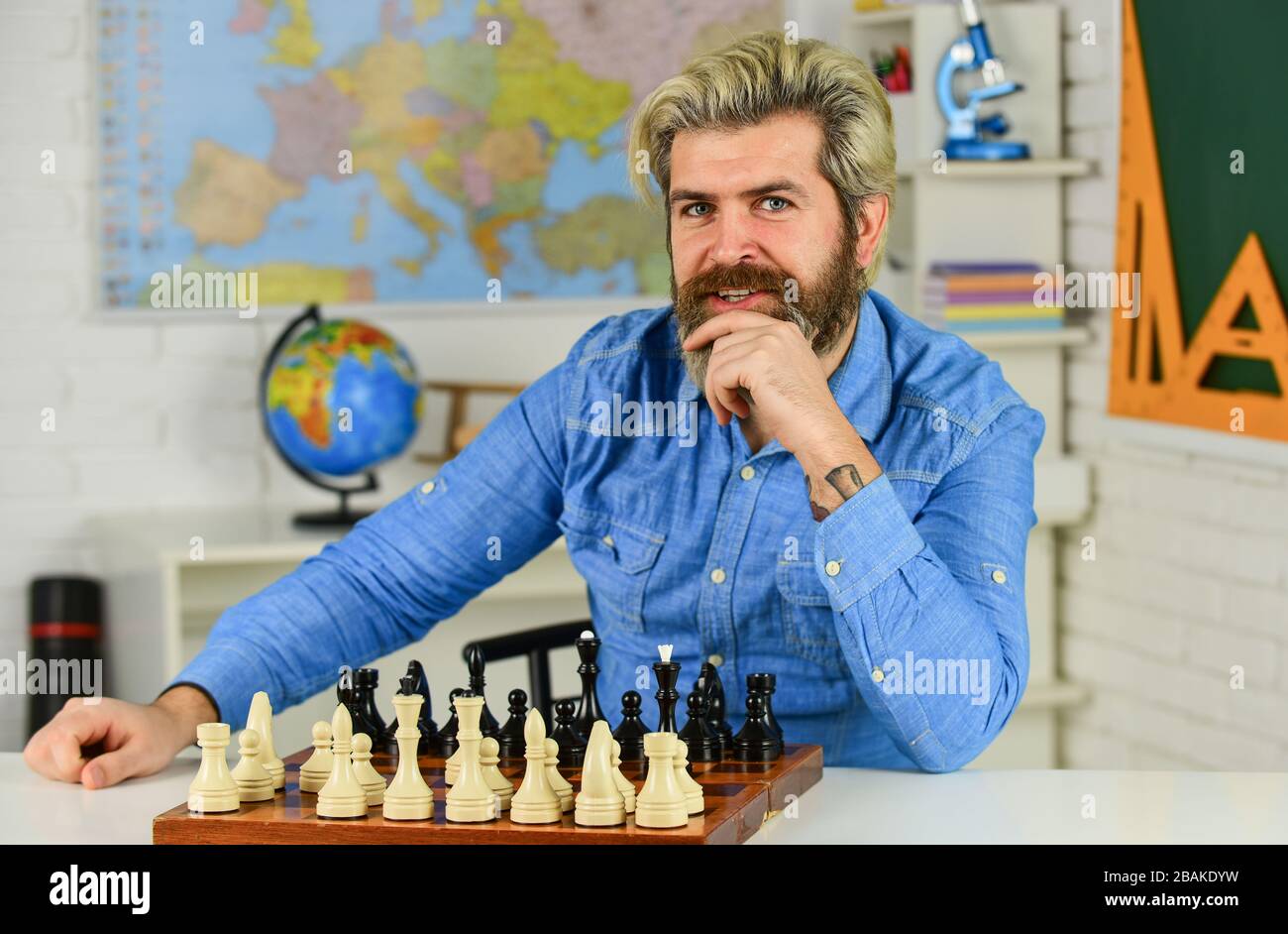 brain works like a muscle. Concentrated man developing chess strategy ...