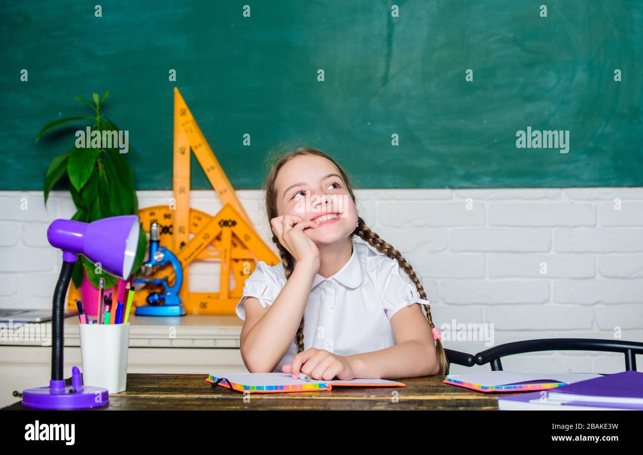 Hooked on learning. Girl cute child sit school classroom chalkboard ...
