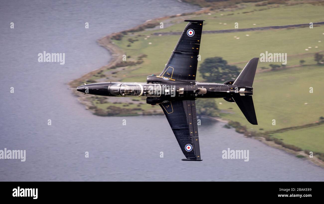 Royal Air Force (RAF) Hawk training jet from RAF Valley fling low and fast through a valley in ...