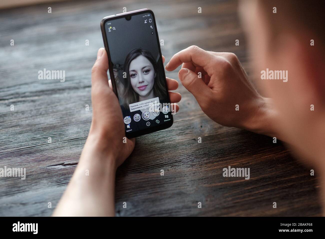An apple iPhone showing the snapchat application alongside other ...