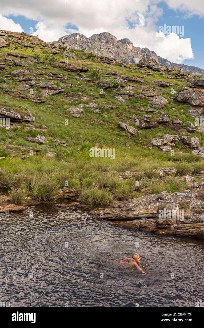A young boy swims in a pool in the Bundi river in Zimbabwe's ...