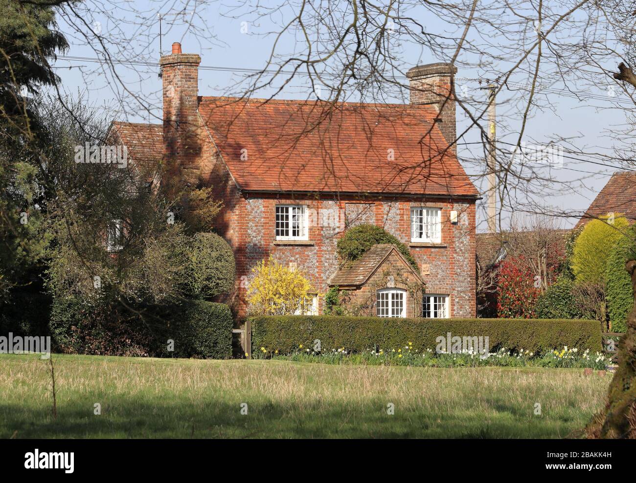A Traditional English Village Brick and Flint Cottage Stock Photo - Alamy