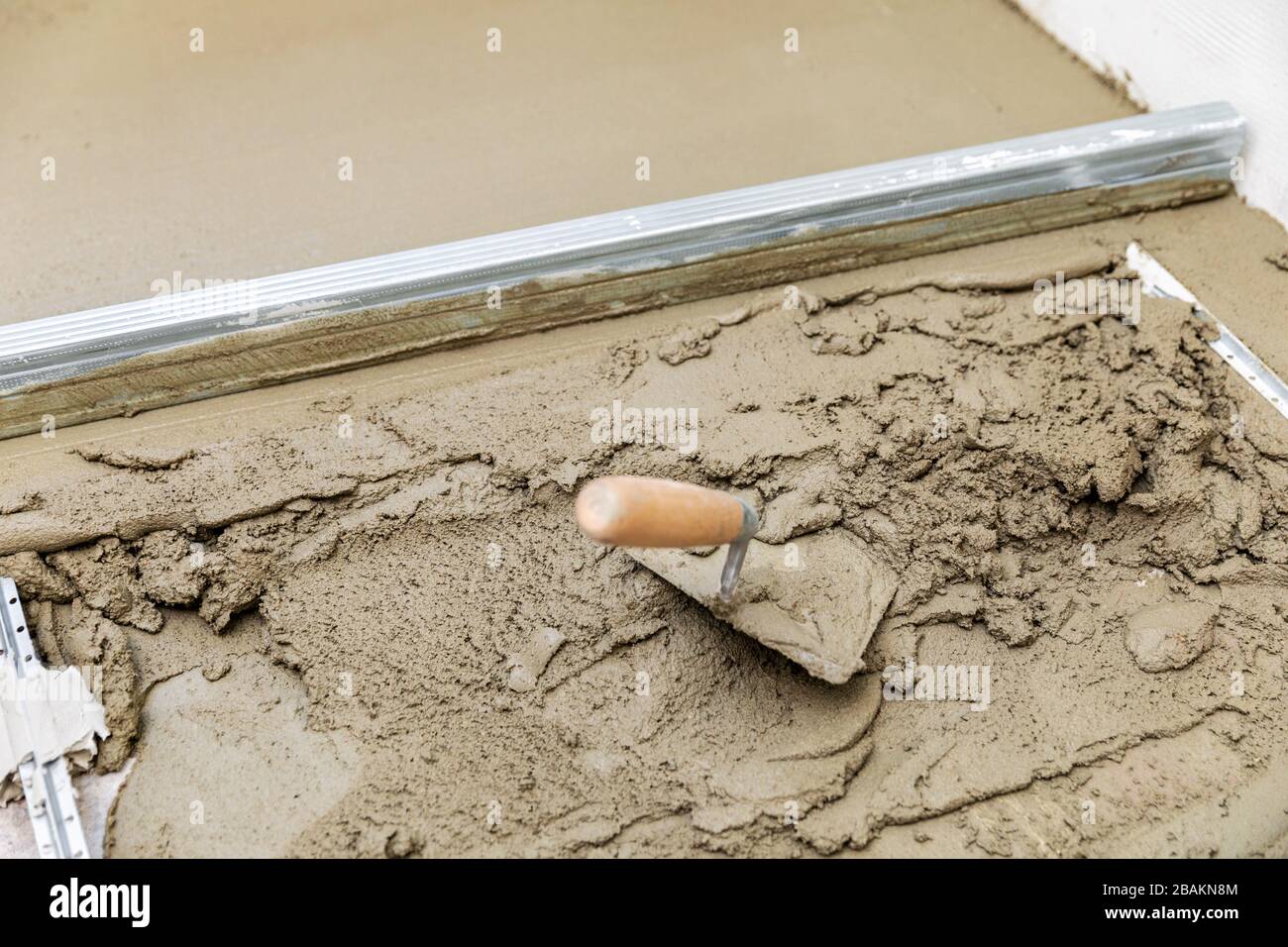 concrete screed floor align. trowel and rail on wet mortar Stock Photo ...