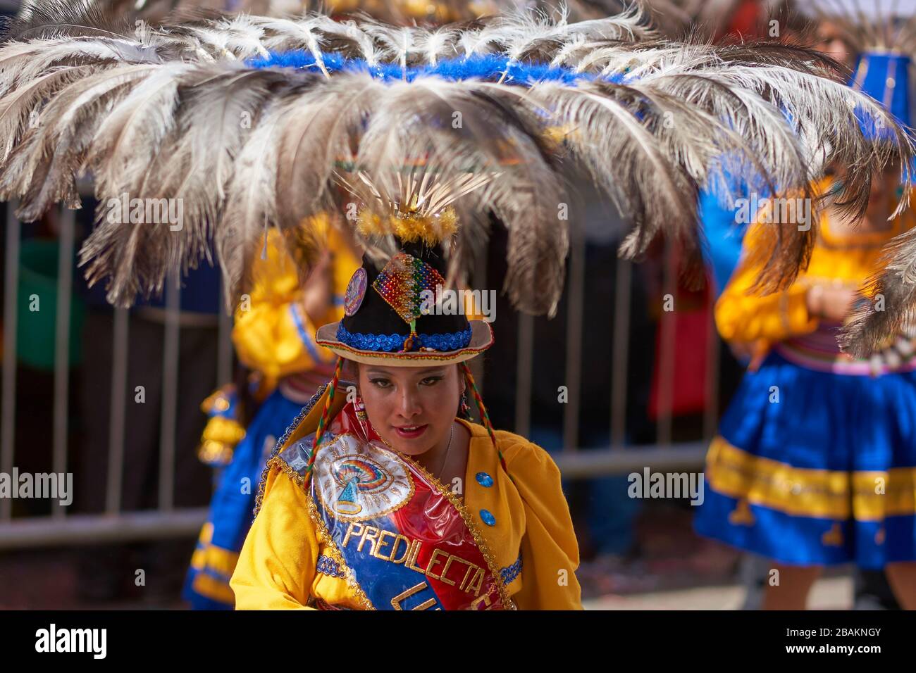 Traditional folk dancers in ornate costumes performing as they parade ...
