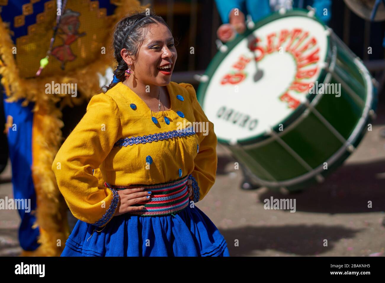 Traditional folk dancers in ornate costumes performing as they parade ...