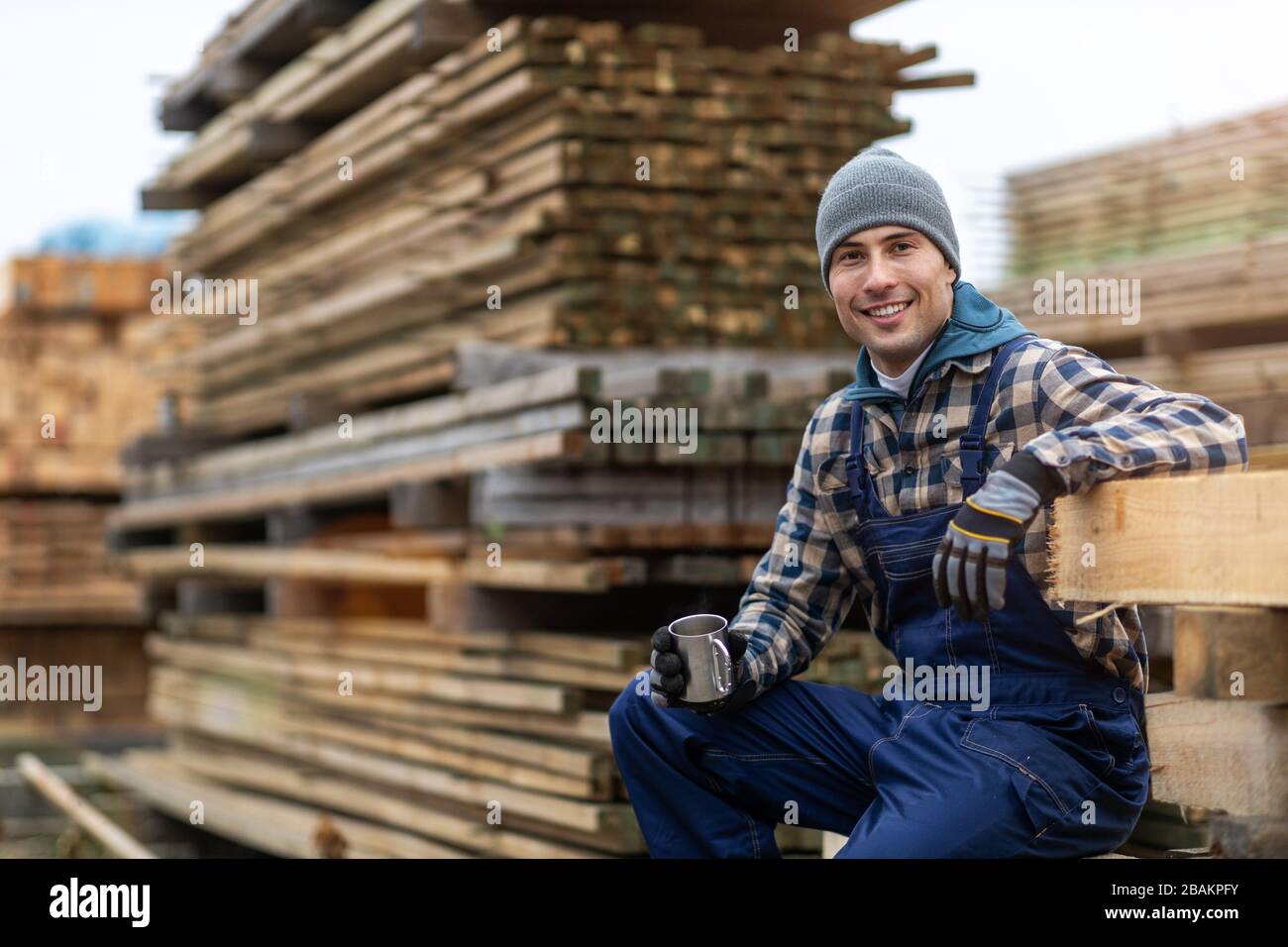 Young male worker in timber warehouse Stock Photo - Alamy