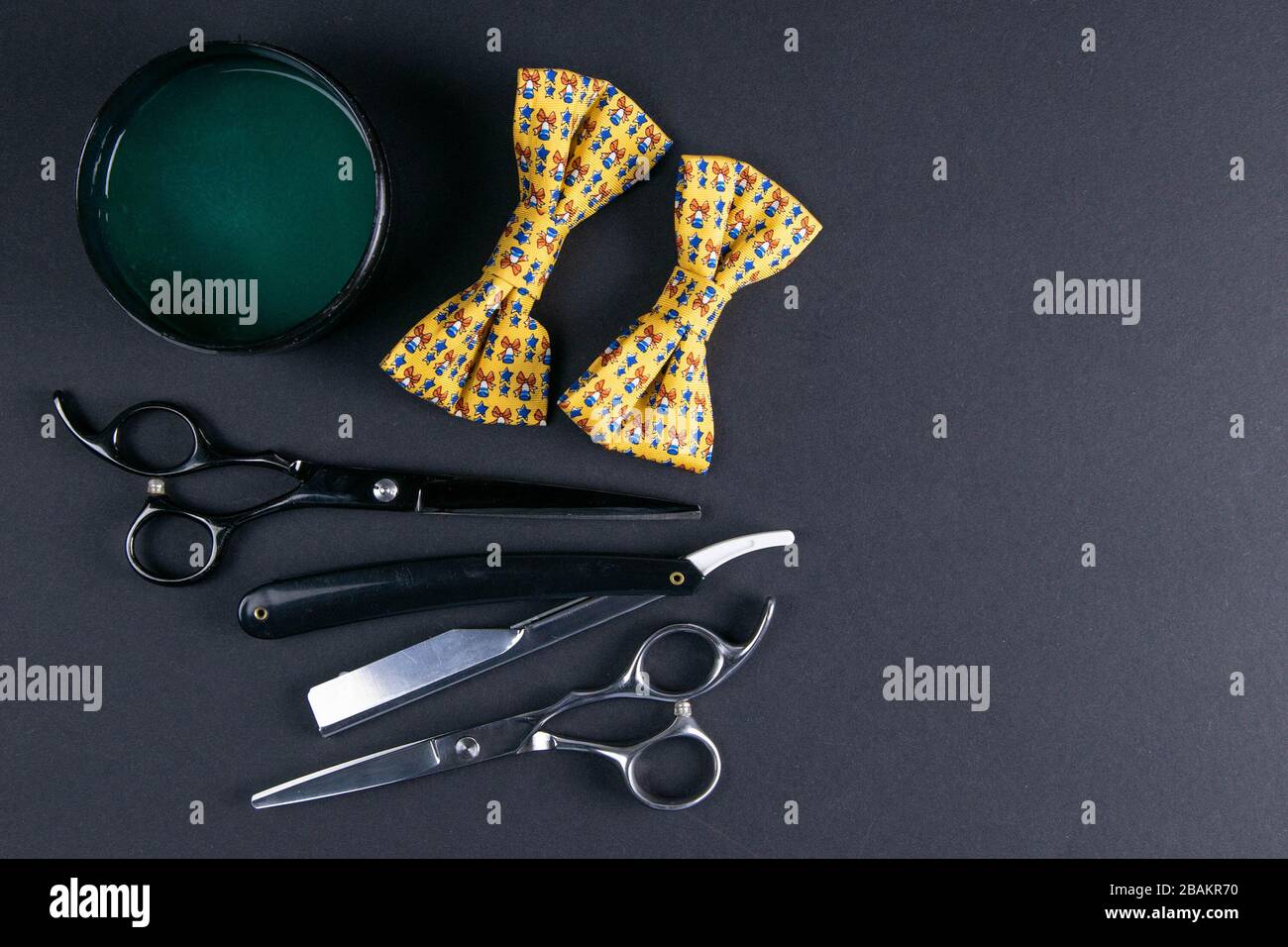 Dangerous razor, shaving gel, haircut scissors and two yellow male ...