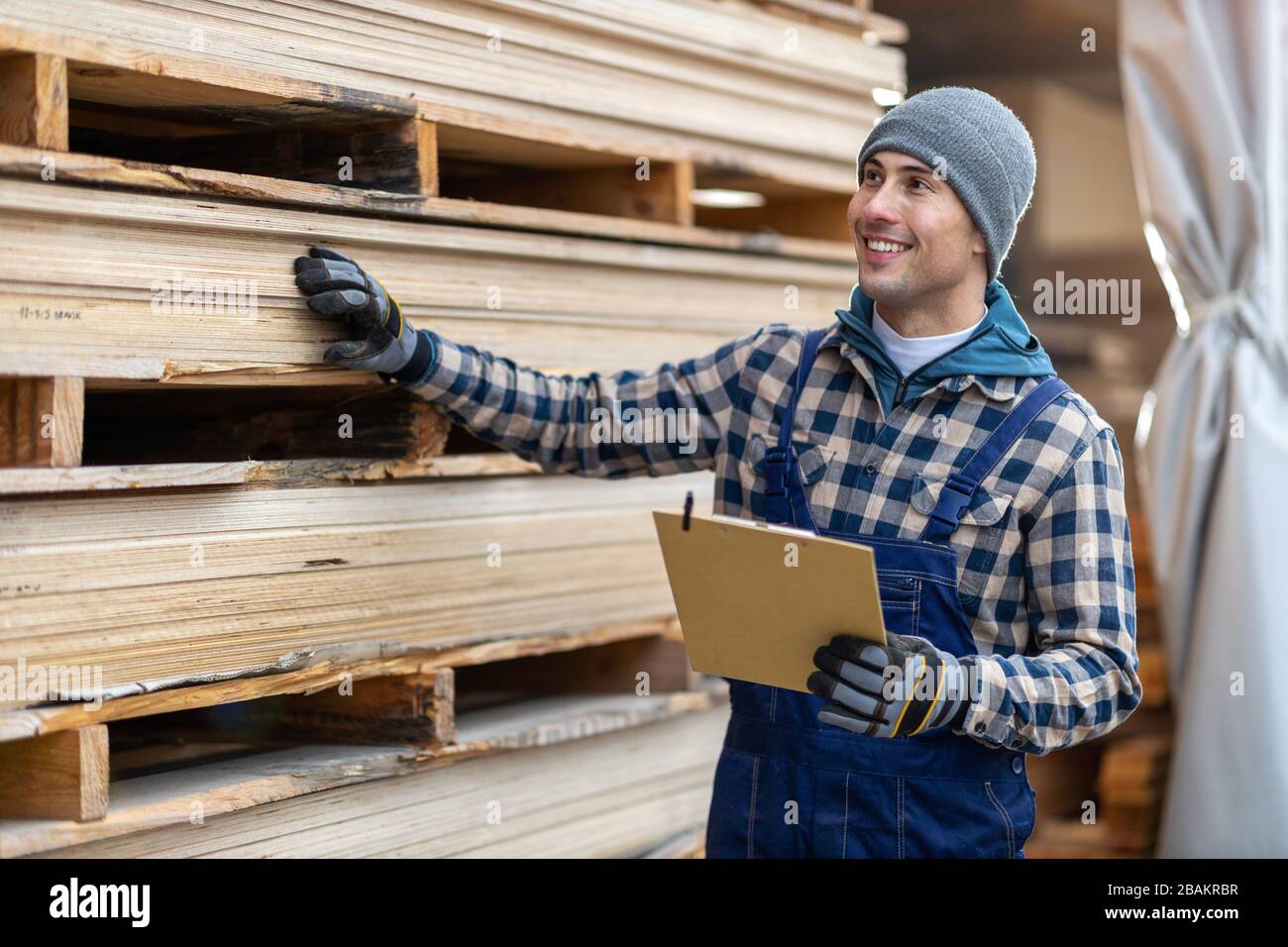 Young male worker in timber warehouse Stock Photo - Alamy