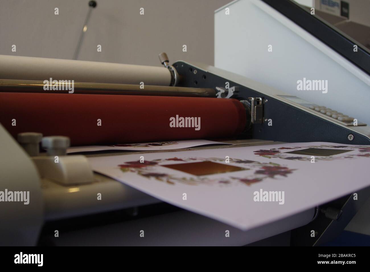 Plastic laminating machine Stock Photo - Alamy